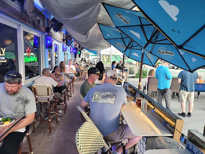 The outdoor seating area offers the perfect Florida trifecta: sea breeze, cold drinks, and the promise of fresh seafood just moments away.