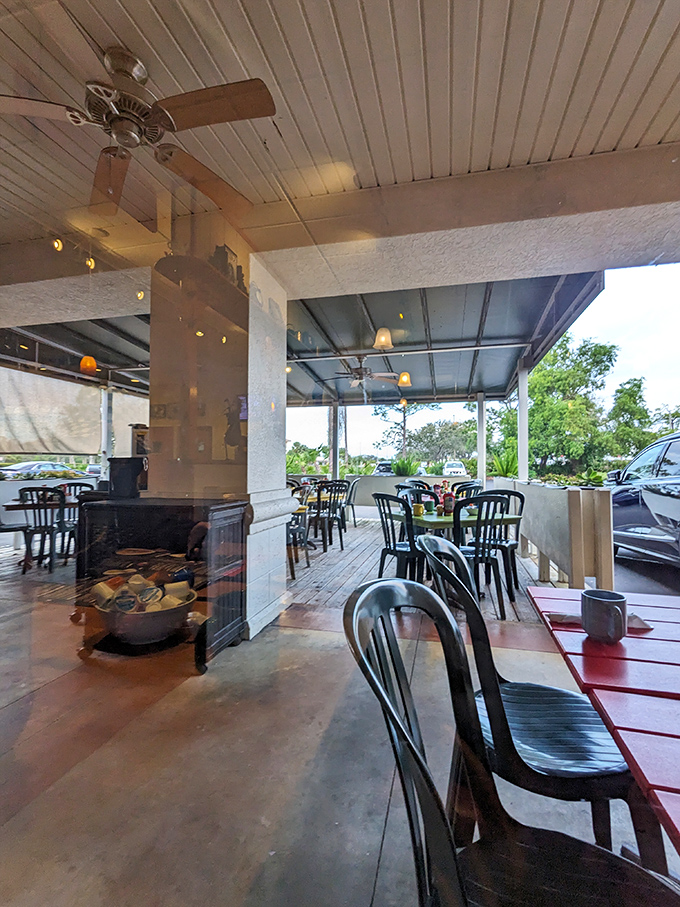 The outdoor seating area offers Florida's version of al fresco dining – ceiling fans overhead, coffee in hand, and no snowstorms in sight.