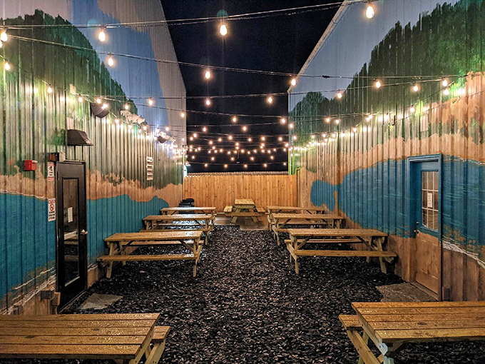 String lights transform this outdoor seating area into a magical BBQ oasis where picnic tables become thrones for feasting on smoky royalty.