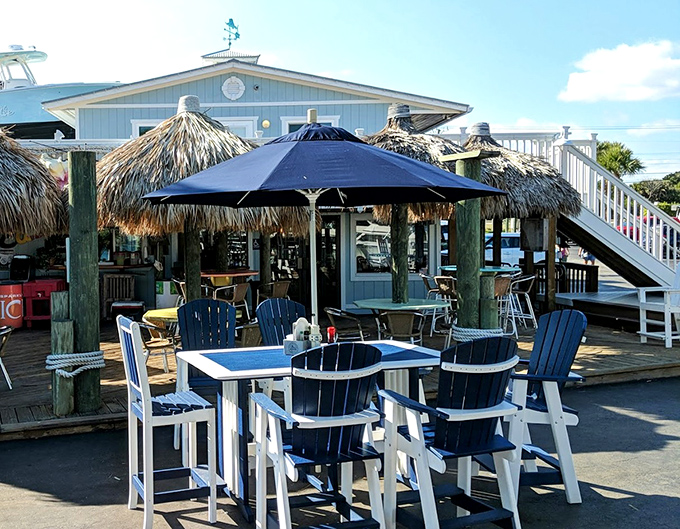 The outdoor seating area isn't just tables and chairs&mdash;it's Florida's living room, where Adirondack blue meets endless sky and waterfront views come standard.