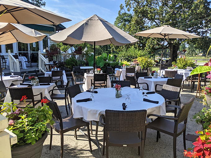 Outdoor dining where umbrellas stand guard against sunshine while white tablecloths signal that casual doesn't mean compromising on elegance.