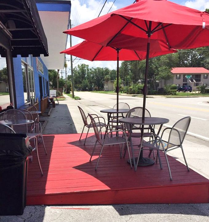 Outdoor seating under bright red umbrellas &ndash; because Florida sunshine and great sandwiches were made for each other.