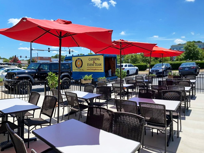 Outdoor seating under cherry-red umbrellas&mdash;because vitamin D and breakfast were always meant to be together.