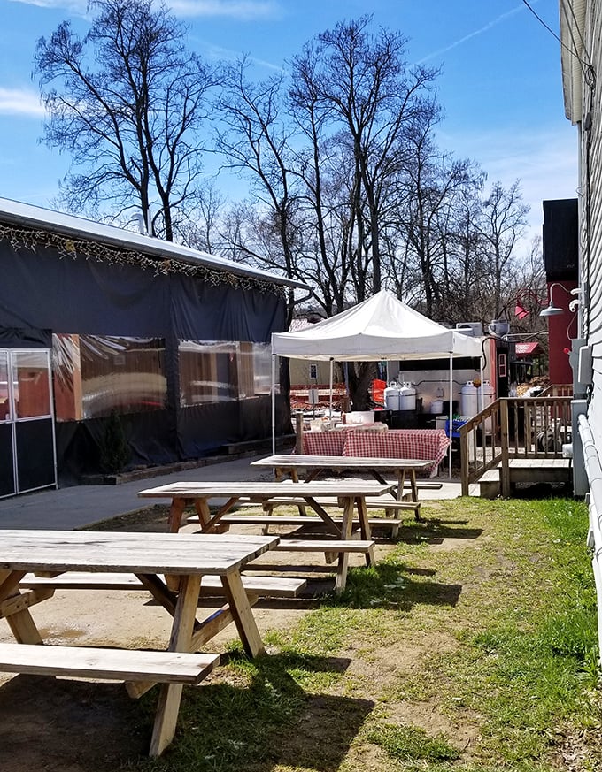Picnic tables waiting for the next round of barbecue pilgrims. In summer, these wooden thrones become the hottest seats in Cincinnati.