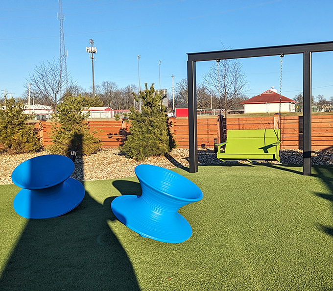 Outdoor seating that's part playground, part lounge area. Those blue chairs look like they fell from a modern art museum&mdash;in the best way.
