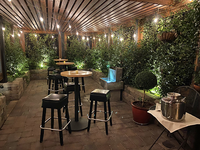 The outdoor patio, wrapped in greenery and soft lighting, feels like dining in a secret garden where meat-lovers go to heaven.