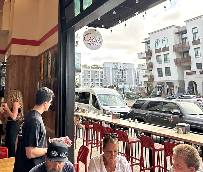 Window seats offer prime people-watching with your pie, where the outside world becomes dinner theater for those lucky enough to snag a spot.