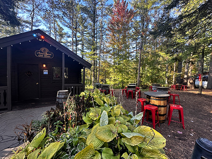 The Arrowhead Bar's outdoor setting, where pine-scented air and barrel tables create the perfect backdrop for pre-dinner drinks.