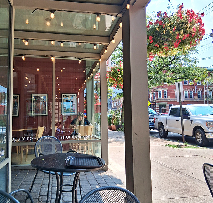 The sidewalk seating area offers a front-row view of Little Italy's charm. Those string lights aren't just decoration – they're a beacon for dessert pilgrims.