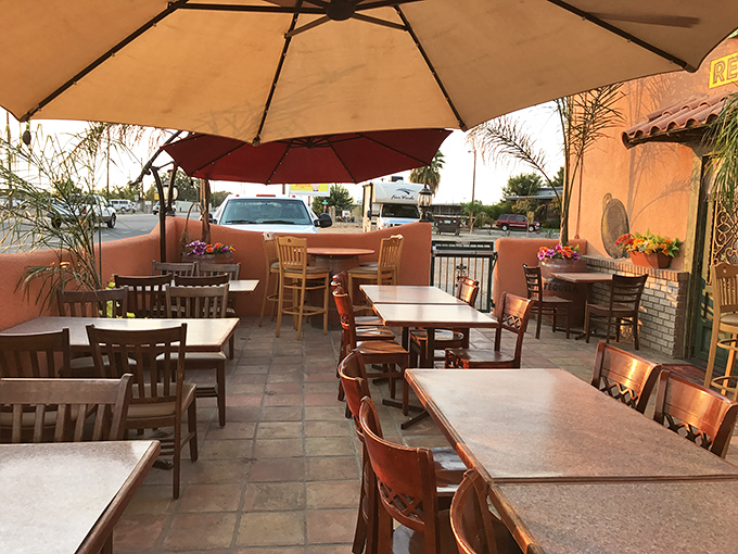 Sunset casts a golden glow on this patio where umbrellas stand guard against the Fresno heat and tables await your next memorable meal.
