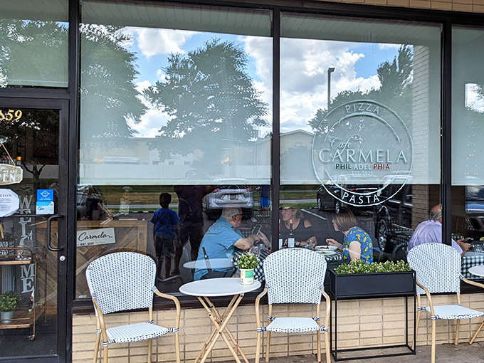 Outdoor seating that invites you to linger over one more glass of wine. The logo promises pizza and pasta, but delivers much more.