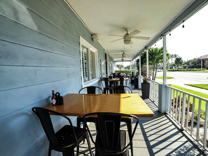 The covered porch seating offers Florida's version of al fresco dining: sunshine without the sunburn, breeze without the bugs.