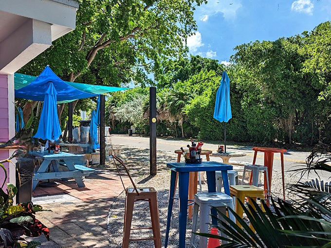 The outdoor seating area offers breakfast with a side of vitamin D, under blue umbrellas that match the Keys sky.