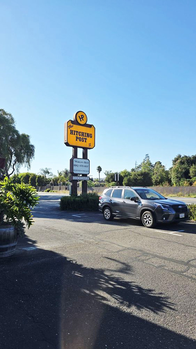 The yellow sign has guided hungry travelers to this culinary landmark for decades, promising "World's Best BBQ Steaks" without exaggeration.