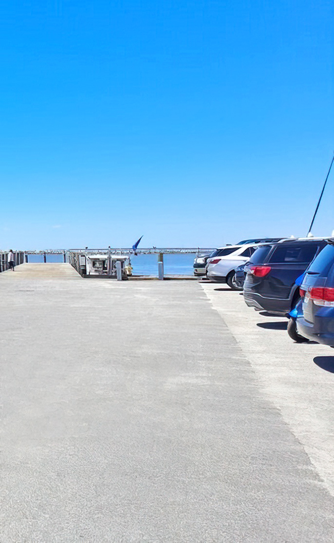 The parking lot view reminds you why you came: where the land meets the Chesapeake, with water so blue it looks Photoshopped.