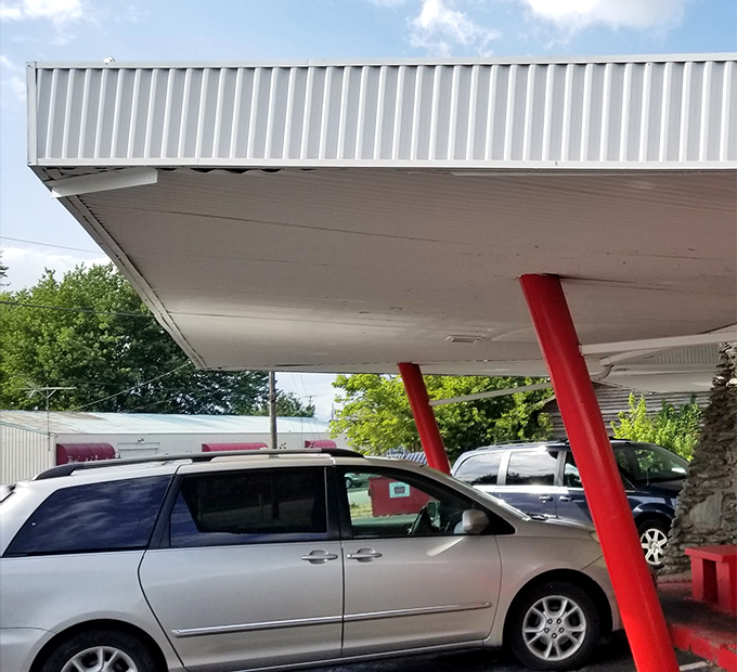 The covered parking area welcomes vehicles of all makes and models&mdash;a democratic approach to dining where your car's price tag doesn't determine your tenderloin quality.