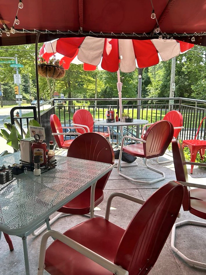 The patio's cheerful red chairs and striped umbrellas create an outdoor oasis that feels like the best backyard party in town &ndash; minus the cleanup.