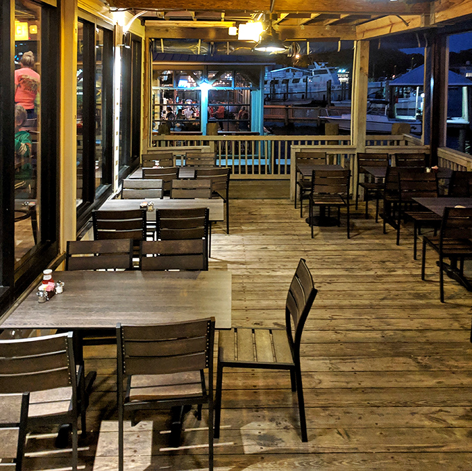 The waterfront deck where evening breezes carry conversations and the day's fishing boats return – dinner and a show, nature's way.