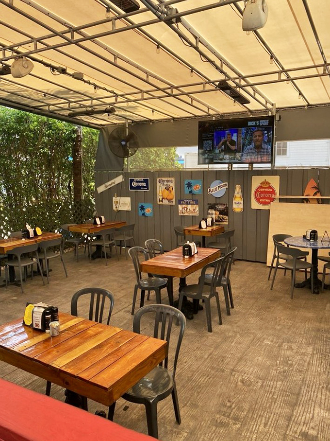 Outdoor seating where beer signs serve as artwork. This patio isn't just dining al fresco&mdash;it's Florida's version of a European caf&eacute;.