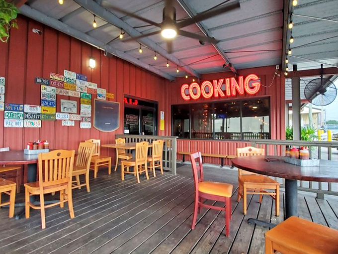 The outdoor seating area with its "COOKING" sign promises al fresco dining where the only thing better than the food is the Florida breeze.