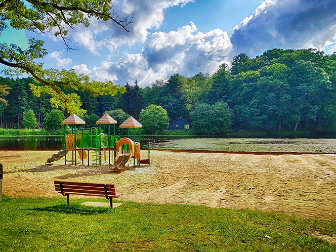 The beach playground: where kids burn energy faster than your fitness tracker can count steps, while you contemplate a "quick rest" on that inviting bench.