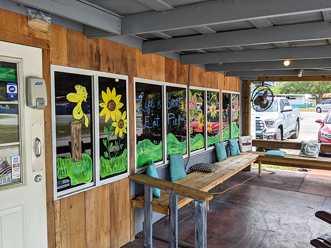 Hand-painted sunflower murals brighten the porch waiting area, a cheerful preview of the sunny hospitality waiting inside. 