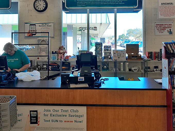 The checkout counter: final gateway between you and your thrifting victory. The text club sign promises even more savings for dedicated bargain hunters.