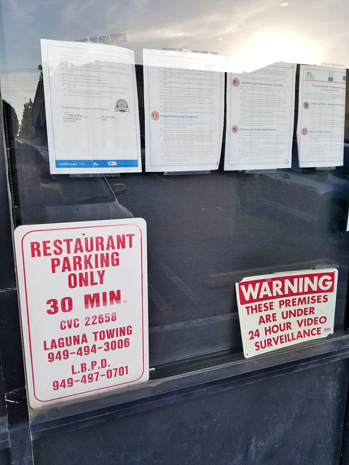 The fine print of burger paradise. Even the parking rules can't dampen the excitement of what awaits inside these hallowed walls.