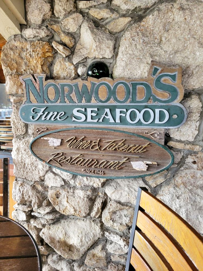 The stone wall sign announces your arrival at seafood paradise. Like finding the entrance to Narnia, but with better appetizers.