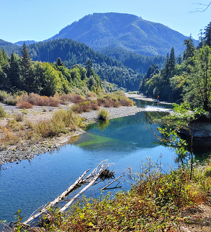 The Chetco River valley unfolds like a landscape painting you can actually walk into. Those mountains aren't just a view&mdash;they're an invitation.