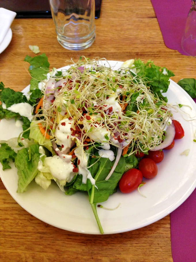 A garden on a plate, where sprouts and greens perform the culinary equivalent of virtue signaling before you hit the dessert table.