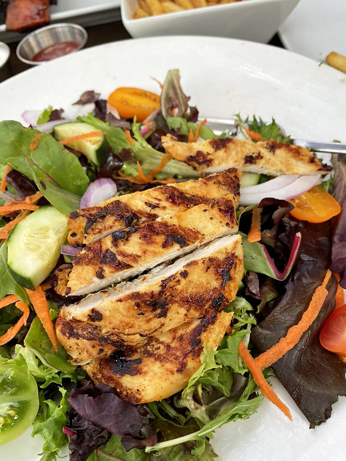 Even the salads get the star treatment&mdash;grilled chicken perched atop fresh greens proves barbecue joints can do balance too. 