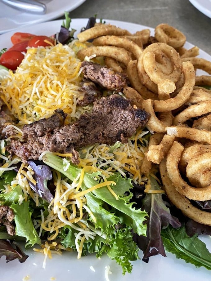 A salad that doesn't apologize for being healthy – crisp greens, shredded cheese, and those curly fries saying "we're all friends here."