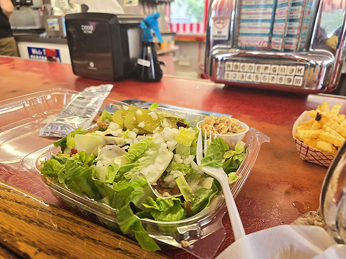 This isn't just a side salad—it's proof that even the simplest dishes get respect here. Crisp lettuce, pickles, and coleslaw offering a refreshing counterpoint to heartier fare.