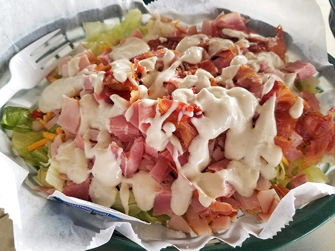 This isn't just a salad – it's a celebration of contrasts where crisp lettuce meets savory toppings under a blanket of creamy dressing.