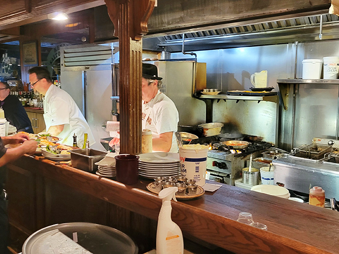 A glimpse into the kitchen reveals the orchestrated chaos where seafood masterpieces are born through skill and dedication.