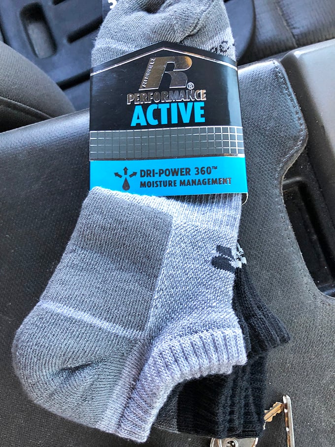 Brand new athletic socks still sporting their tags—proof that thrift store shopping isn't always about someone else's castoffs.
