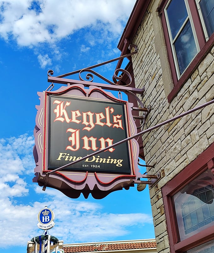 The sign hangs proud against blue skies, a beacon calling all hungry souls to German food paradise.