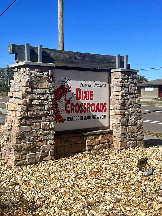 The roadside sign stands as a beacon for seafood pilgrims. That cartoon shrimp knows exactly what treasures await inside.