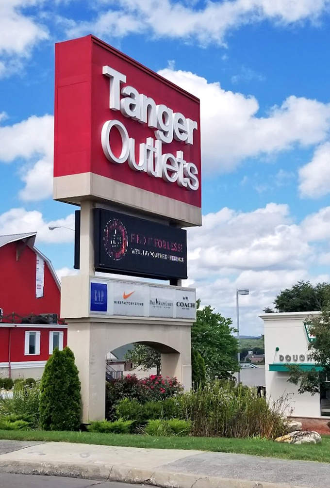 The red Tanger sign against Missouri sky—like a retail North Star guiding bargain hunters home from miles around.