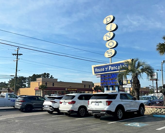 The vintage sign stands tall against Carolina blue skies, a beacon for breakfast pilgrims seeking pancake salvation.