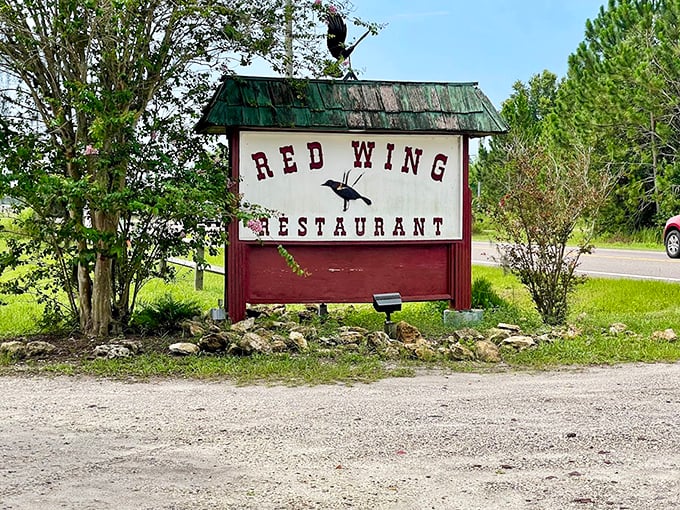 The roadside sign stands as a beacon to hungry travelers &ndash; a promise of good things to come just down the gravel drive.