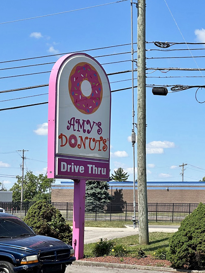 The pink sign stands like a beacon of hope for the sugar-deprived, promising sweet salvation just ahead.