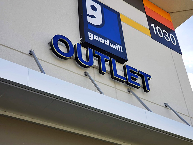 The blue Goodwill smile logo&mdash;a beacon for bargain hunters. This sign promises adventures in affordable retail therapy unlike any other.