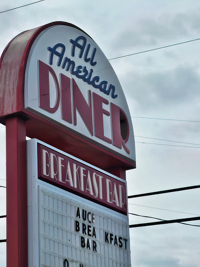 The roadside sign stands as a beacon of hope for hungry travelers, promising "BREAKFAST BAR" in letters that practically whisper, "Pull over, you know you want to."