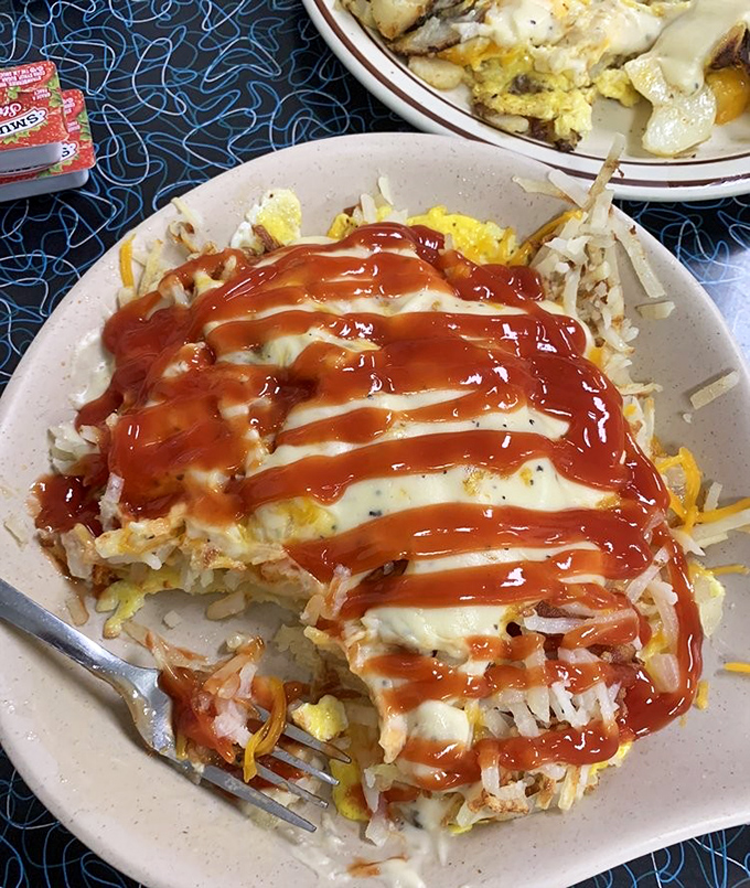 Breakfast architecture at its finest&mdash;eggs, hash browns, and cheese creating the Taj Mahal of morning satisfaction. Ketchup artfully applied.