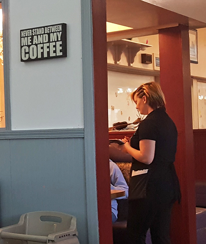 The wall sign speaks truth to power: "Never stand between me and my coffee." Words to live by in any breakfast establishment.
