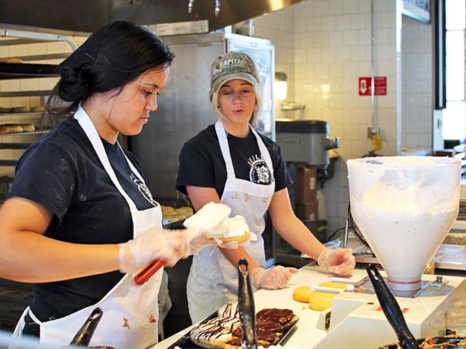 The artisans at work, crafting donuts with the precision of Swiss watchmakers and the soul of Italian grandmothers.
