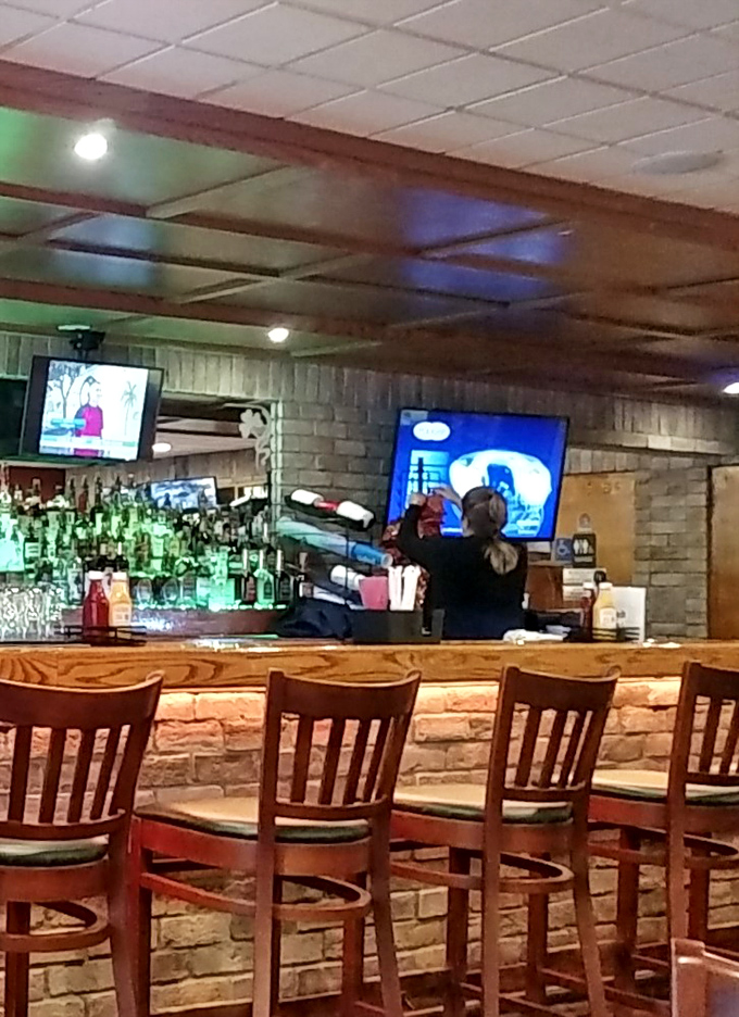 The bartender keeps an eye on multiple screens while tending to thirsty patrons. Multitasking is an art form at McGarrey's.