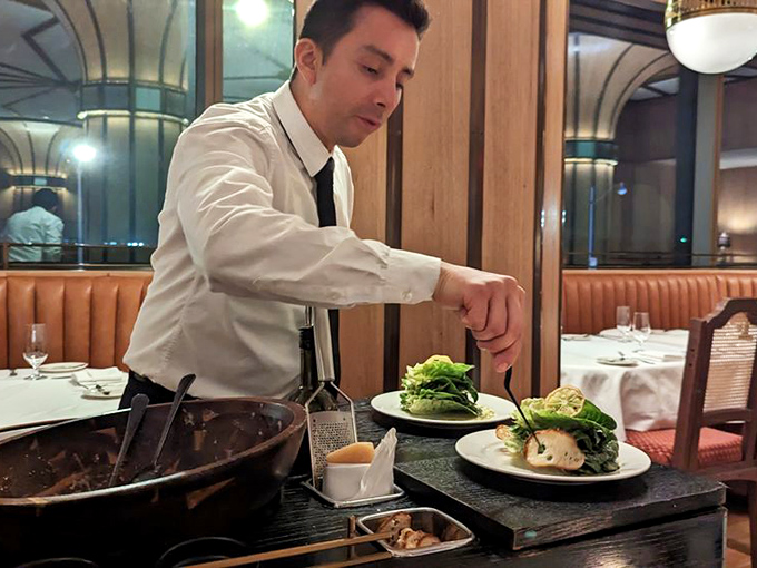 Tableside service: when your salad deserves its own choreography. This isn't just dinner—it's dinner and a show, minus the bad community theater acting.